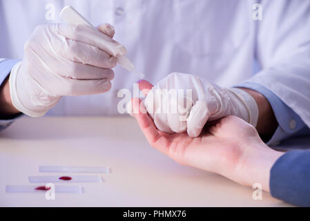 Doctor taking blood samples from finger Stock Photo - Alamy
