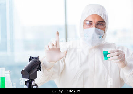 Young chemist pressing virtual buttons in lab Stock Photo - Alamy