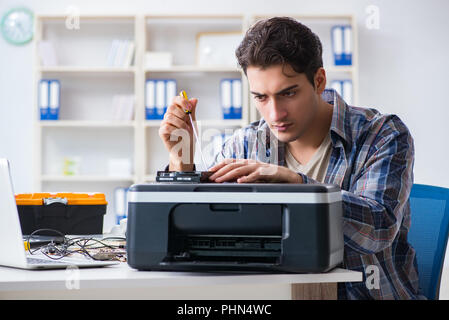 Hardware repairman repairing broken printer fax machine Stock Photo - Alamy