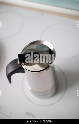 Geyser coffee maker on electric stove in kitchen Stock Photo - Alamy