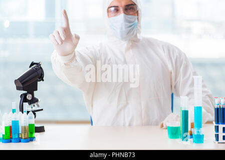 Young chemist pressing virtual buttons in lab Stock Photo - Alamy