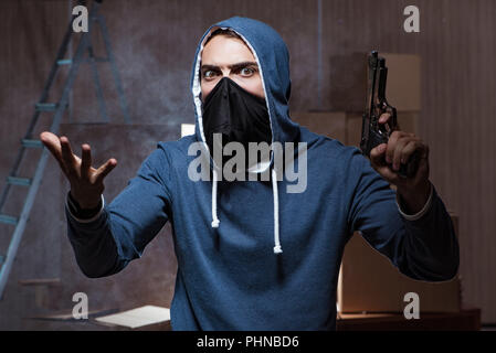 Aggressive manwith gun wearing face mask Stock Photo - Alamy