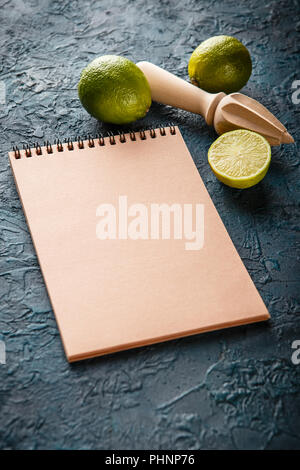 Fresh limes with citrus juicer stick Stock Photo - Alamy
