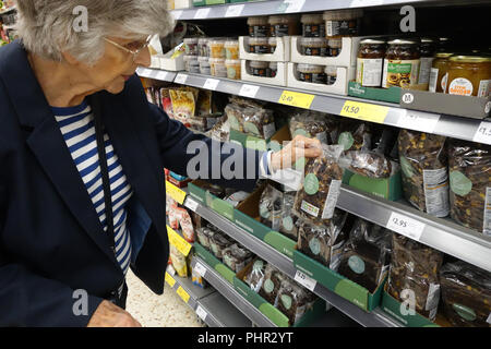 Elderly lady supermarket shopping at Morrisons, Halfway, Sheffield ...