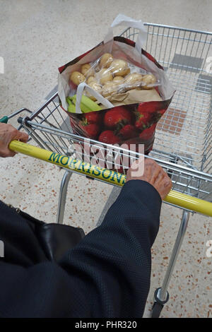 Looking down at a Morrison’s shopping trolley in a supermarket car park ...