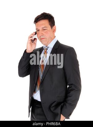 business man talking on a smartphone sitting in the living room Stock ...