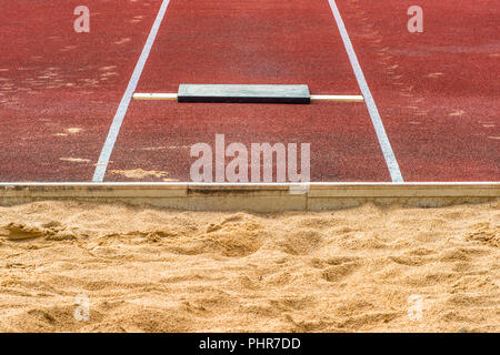 Sand pit for the long jump competition at the school athletics stadium ...