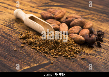 cacao beans and cacao powder in spoon Stock Photo - Alamy