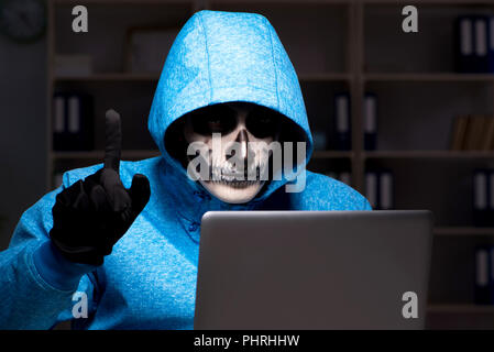 Scary hacker hacking security firewall late in office Stock Photo - Alamy