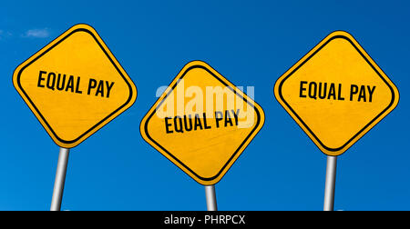 Equal pay, yellow signs with blue sky Stock Photo - Alamy