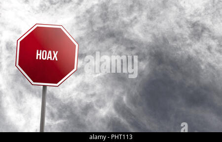 hoax - red sign with clouds in background Stock Photo - Alamy