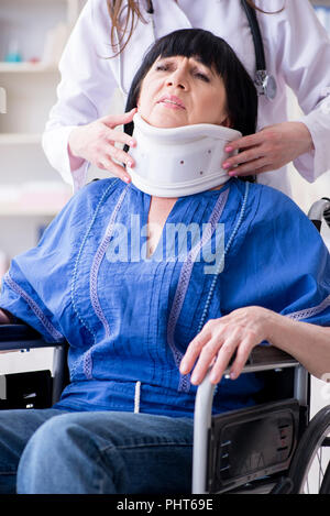 Senior woman with neck injury at doctors Stock Photo - Alamy