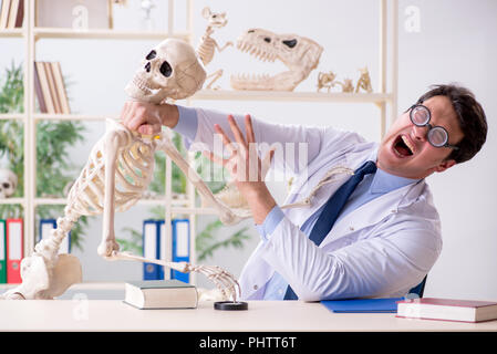 Crazy professor studying human skeleton Stock Photo - Alamy