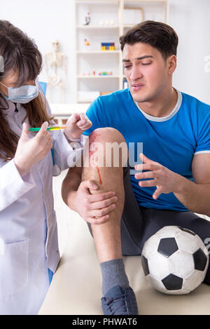 Football soccer player visiting doctor after injury Stock Photo - Alamy