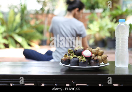 Girl with water during yoga Stock Photo - Alamy