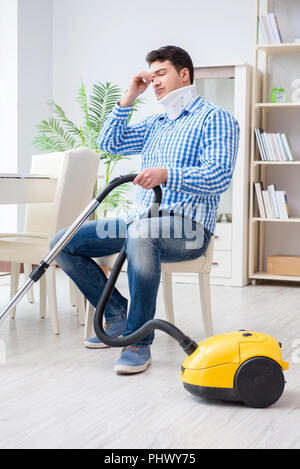 Injured man with neck injury vacuum cleaning house Stock Photo - Alamy