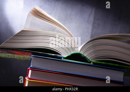 Composition with open book on the table Stock Photo - Alamy
