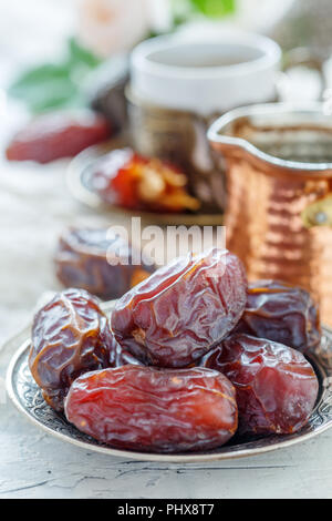 A cup of coffee and dry dates with white isolated background Stock ...