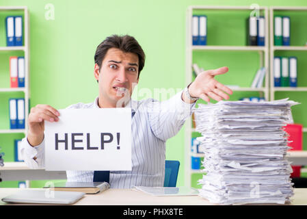 Businessman having problems with paperwork and workload Stock Photo - Alamy