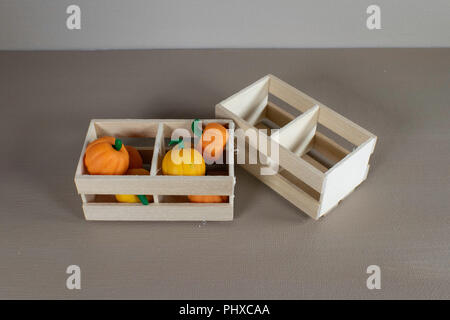 A pair of handmade wooden crates one filled with fake pumpkins and the ...