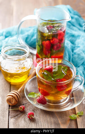Tea with raspberries and honey in a glass teapot Stock Photo - Alamy