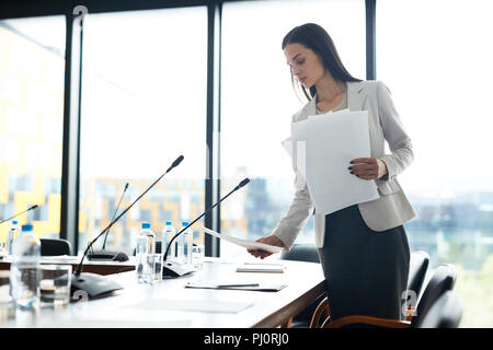 Secretary preparing the meeting room Stock Photo - Alamy