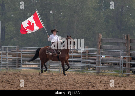 Rodeo cowgirl riding horse carrying American flag during the 4th Annual ...