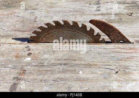 A closeup of an old rusty circular saw on a table Stock Photo - Alamy