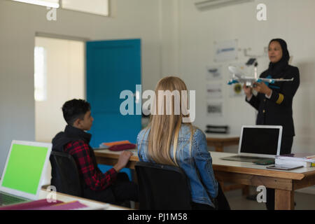 Female pilot teaching about model plane to kids Stock Photo - Alamy