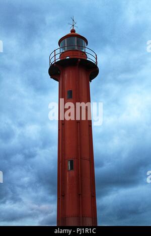 Red lighthouse in the port of Cacilhas village in Lisbon on a gray and ...