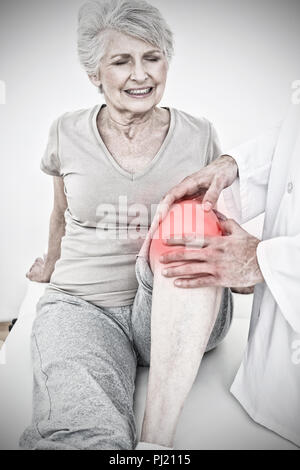 Female Physiotherapist Getting Senior Woman To Use Colourful Fidget Toy ...