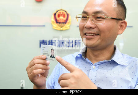 A Taiwan resident living in the Chinese mainland displays the residence ...