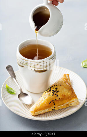Red bean puff pastry served with green tea Stock Photo - Alamy