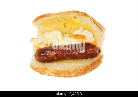 Sausage and fried egg in a giraffe bread roll on a plate isolated ...