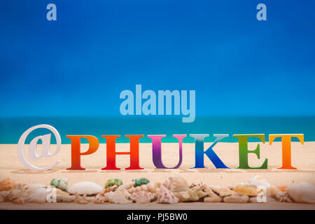 @Phuket written in colorful wood letters with sea shell at the beach ...