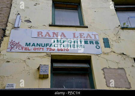 Old 1930s commercial signs on a wall by Spitalfields Church in the City ...