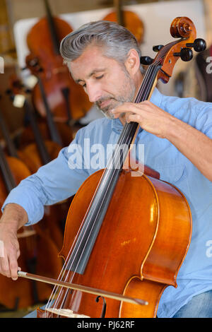 Mature man playing cello Stock Photo - Alamy