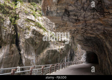 Cliffside road under rock overhang and marble canyons, Tunnel of Nine ...