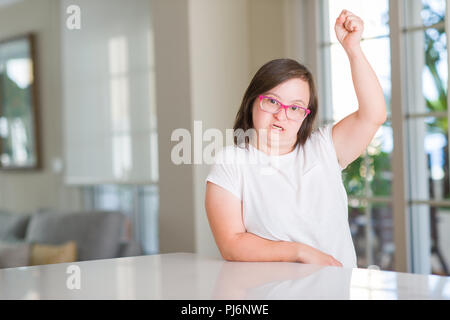 Down syndrome woman at home annoyed and frustrated shouting with anger ...