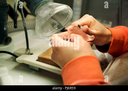 Trimming with scissors Shellac base plates. Dentures. Dental prosthesis ...