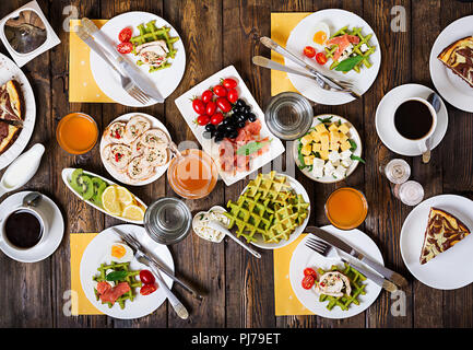 Dining table set for breakfast. Coffee, boiled egg, milk and glass of ...