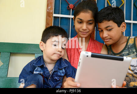 Indian children using Tab Stock Photo - Alamy