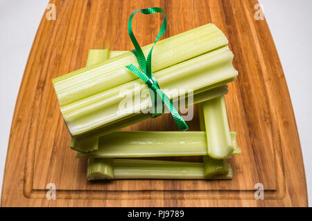 celery bunch stalks on wooden cutting board Stock Photo - Alamy