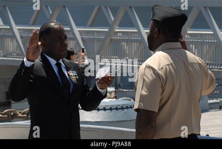 Retired Army Major Frederick Perkins administers the Oath of Re ...