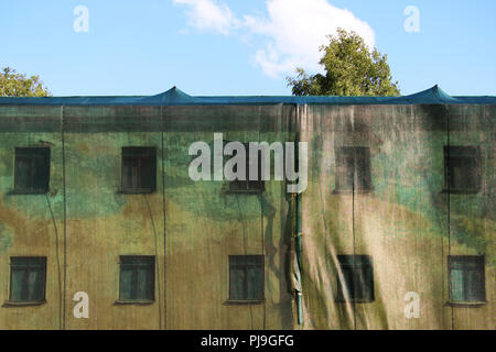 The green building mesh protects the old historical building from ...