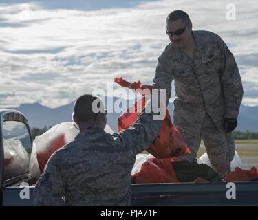 Airmen with the 673rd Logistics Readiness Squadron refuel a C-17 ...
