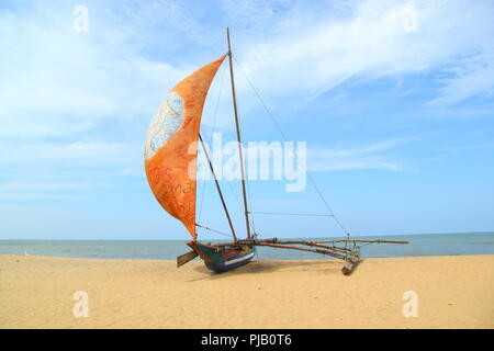 A traditional wooden oruwa fishing boat on shore in Bundala National ...