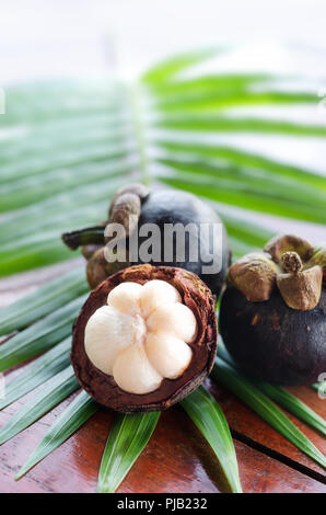Mangosteenes on wooden table Stock Photo - Alamy