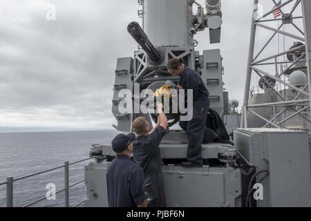 US Navy Fire Controlmen perform a maintenance inspection on a Close-In ...