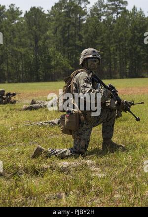 U.S. Marine Corps Sgt. Ian Gomez, right, an imagery intelligence chief ...